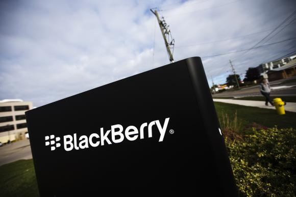 A man walks by a Blackberry sign at the Blackberry campus in Waterloo ...